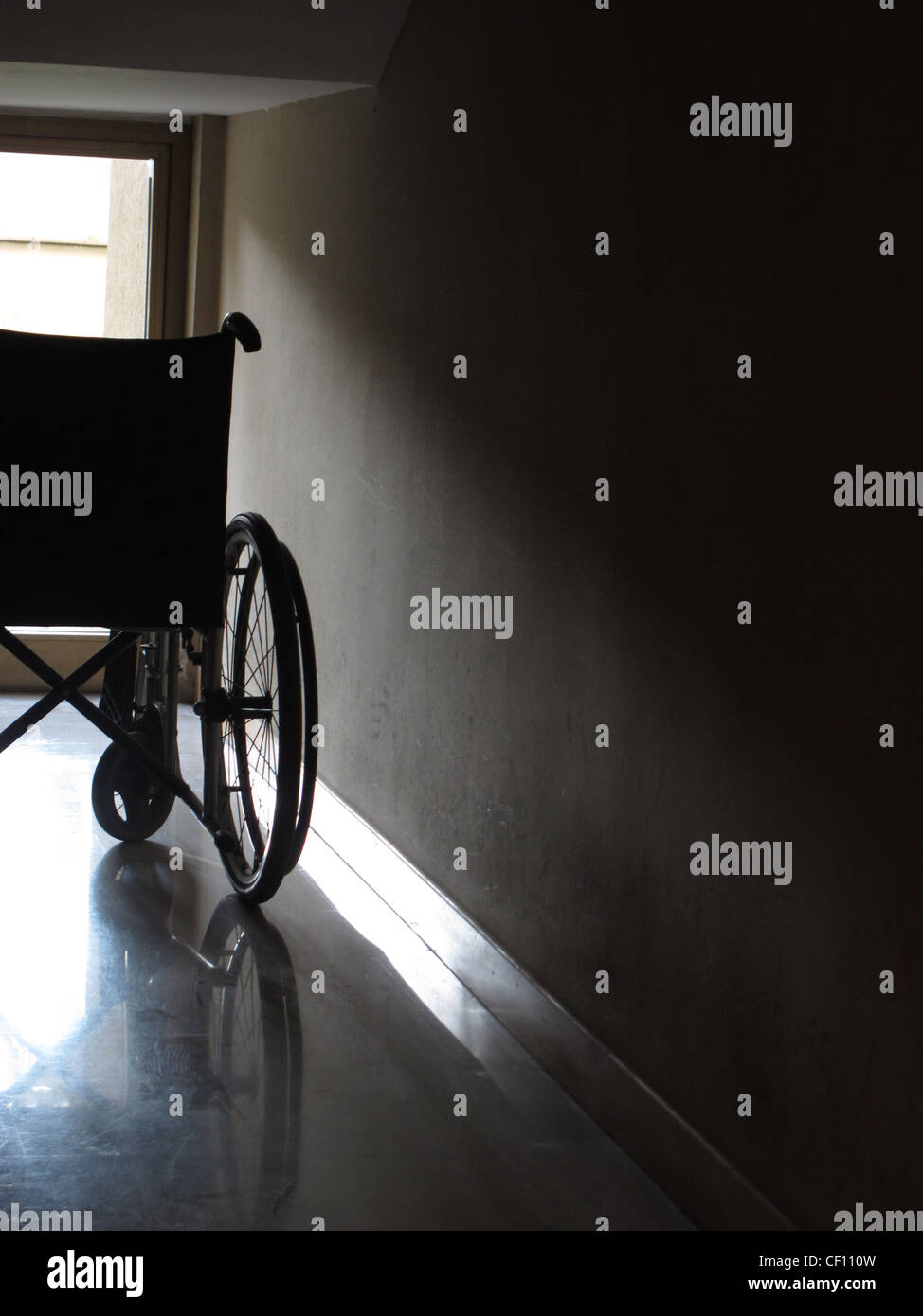 one wheelchair in dark room Stock Photo - Alamy