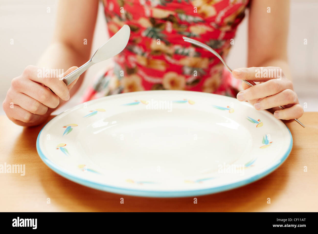 Woman with empty plate Stock Photo - Alamy