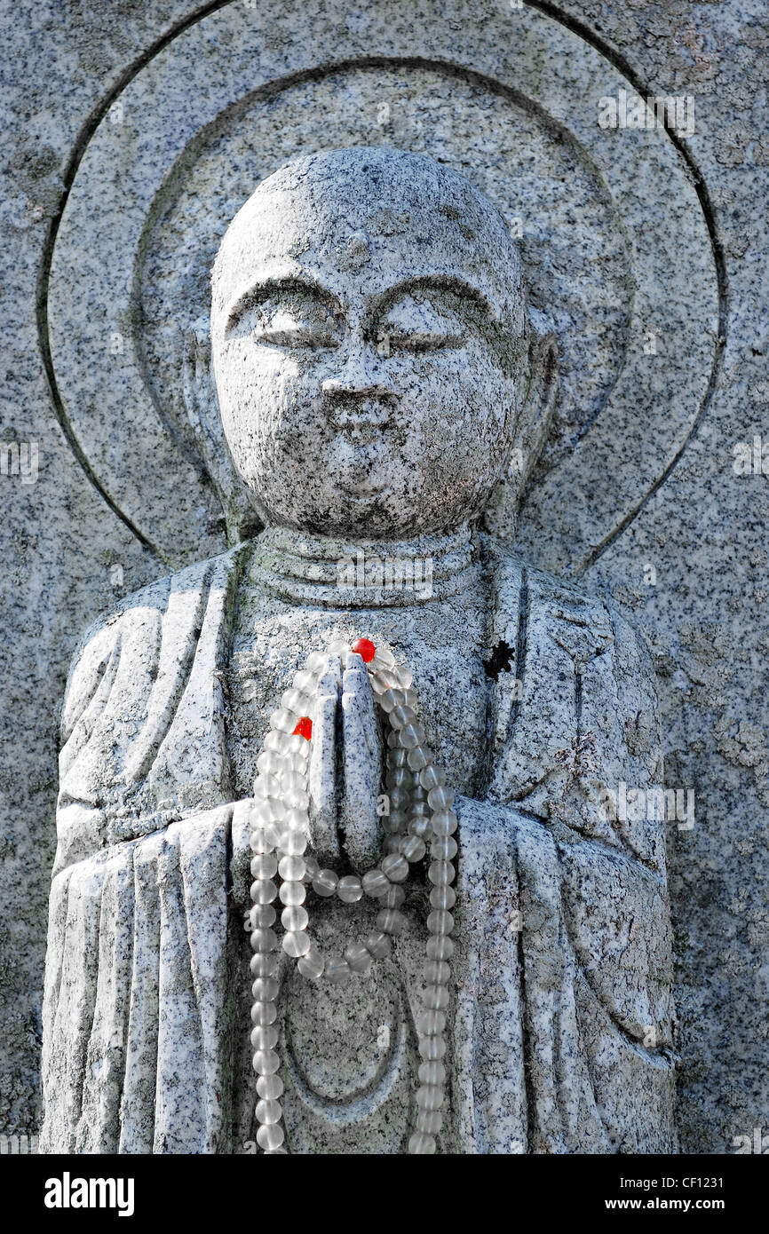 Buddhist Monk Statue with Beads Stock Photo - Alamy