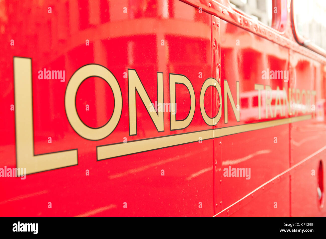 A sign for London Transport on the side of a old red route master bus ...