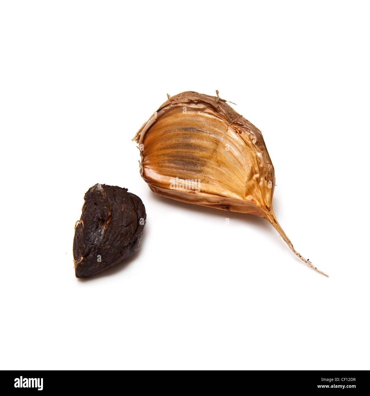 clove of smoked black garlic isolated on a white studio background ...