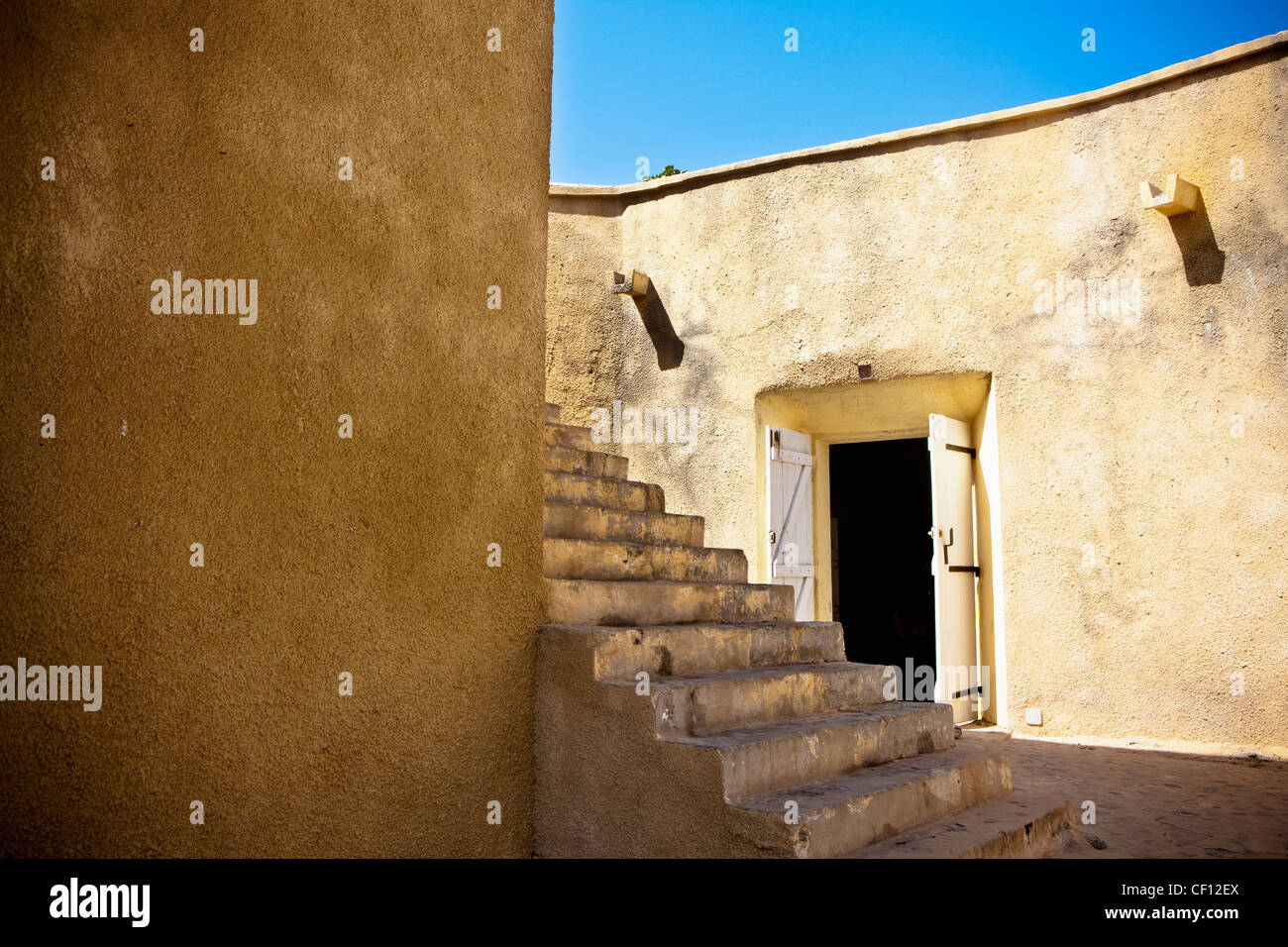A Concrete Stairway Beside A Pale Yellow Building; Dakar Senegal Stock ...