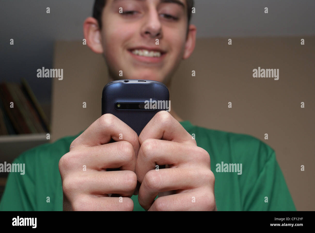 Teenager enjoying a cellphone message Stock Photo - Alamy