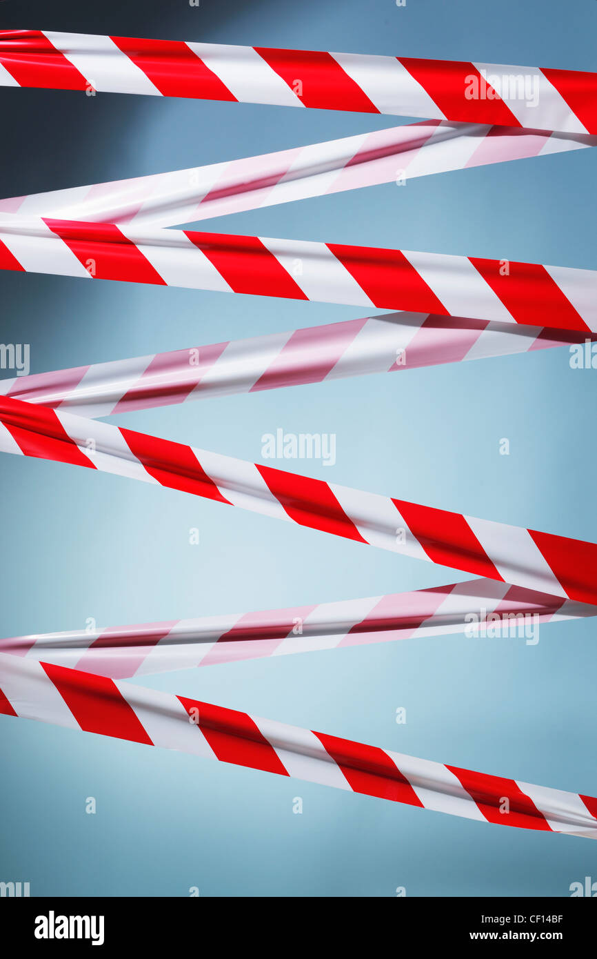 Red and white plastic barrier tape blocking the way Stock Photo - Alamy