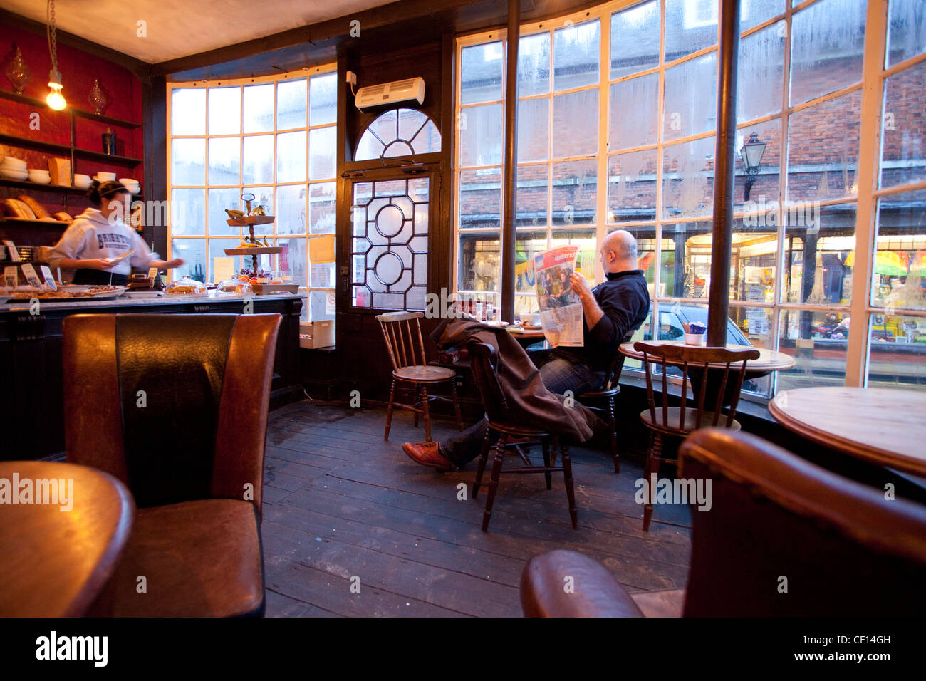 A man relaxes in the Apothecary cafe in Rye East Sussex Stock Photo - Alamy