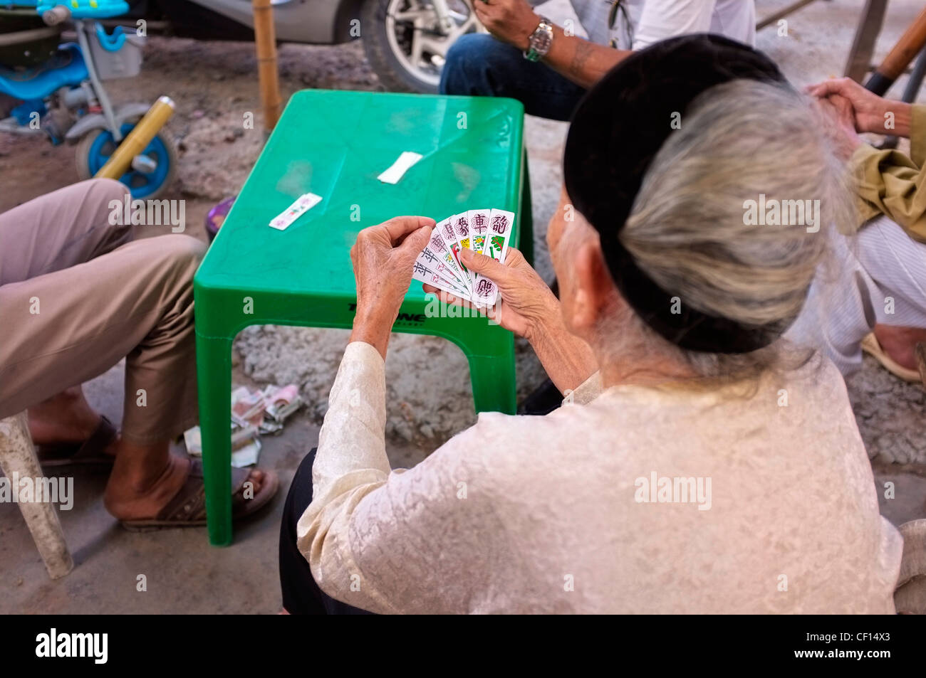Elderly woman playing Tam Cuc card game, Hanoi, Vietnam Stock Photo - Alamy