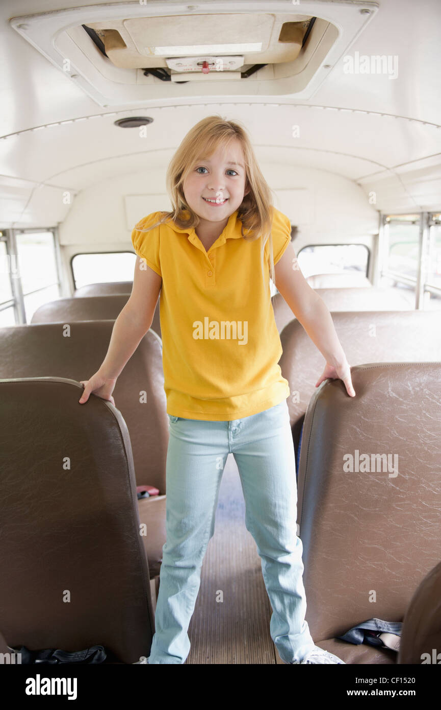 Caucasian girl riding school bus Stock Photo - Alamy