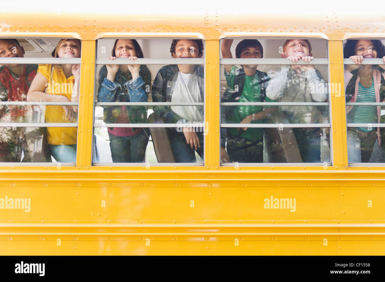 Children riding school bus Stock Photo - Alamy