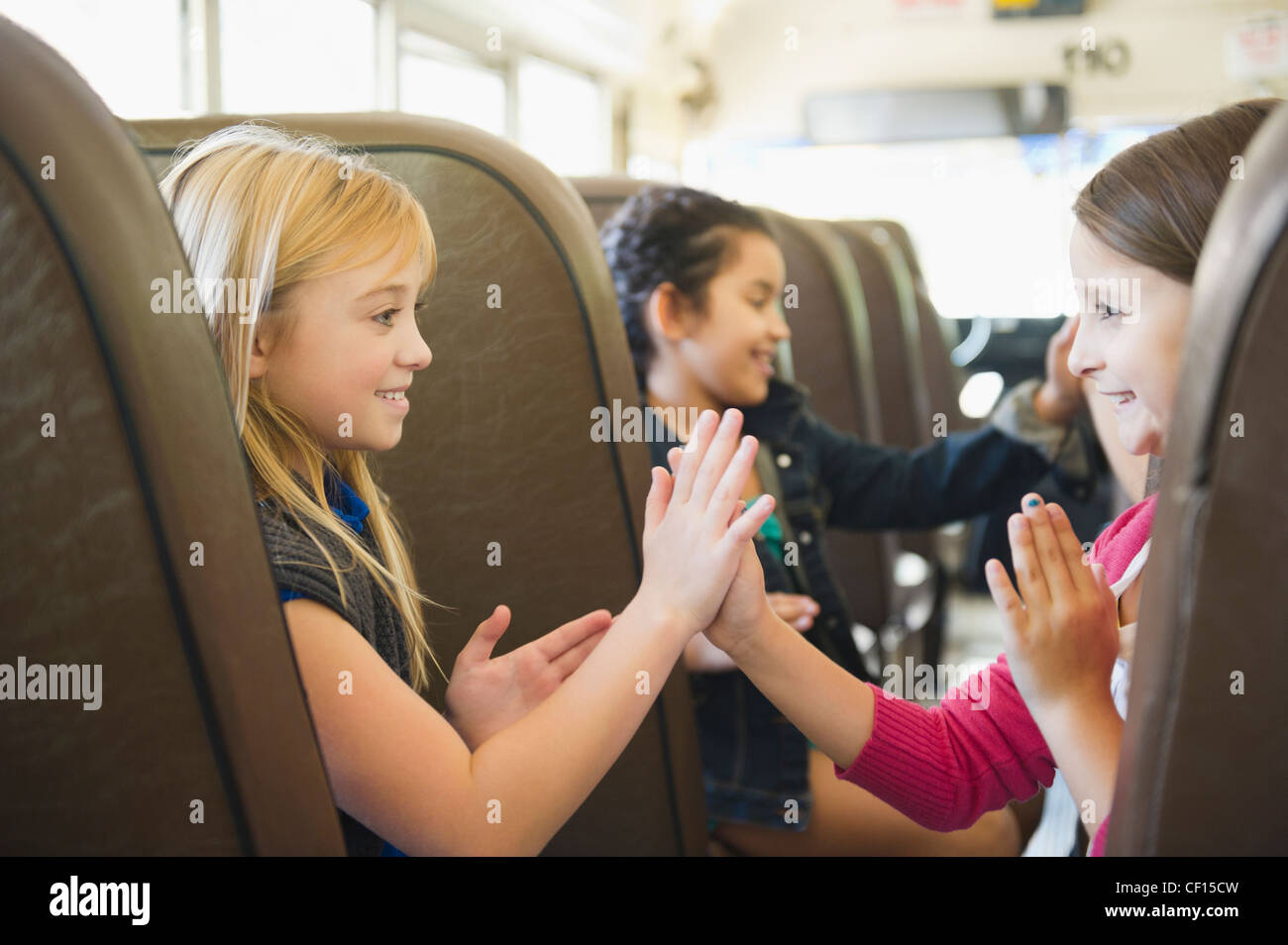Children playing while riding school bus Stock Photo - Alamy