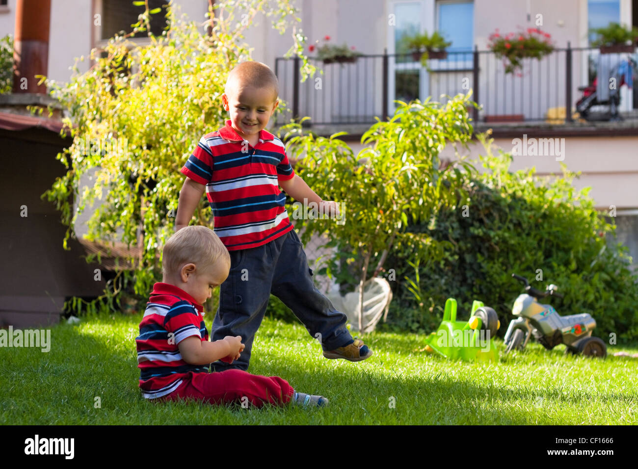 Portrait of two little brothers playing outdoors Stock Photo - Alamy