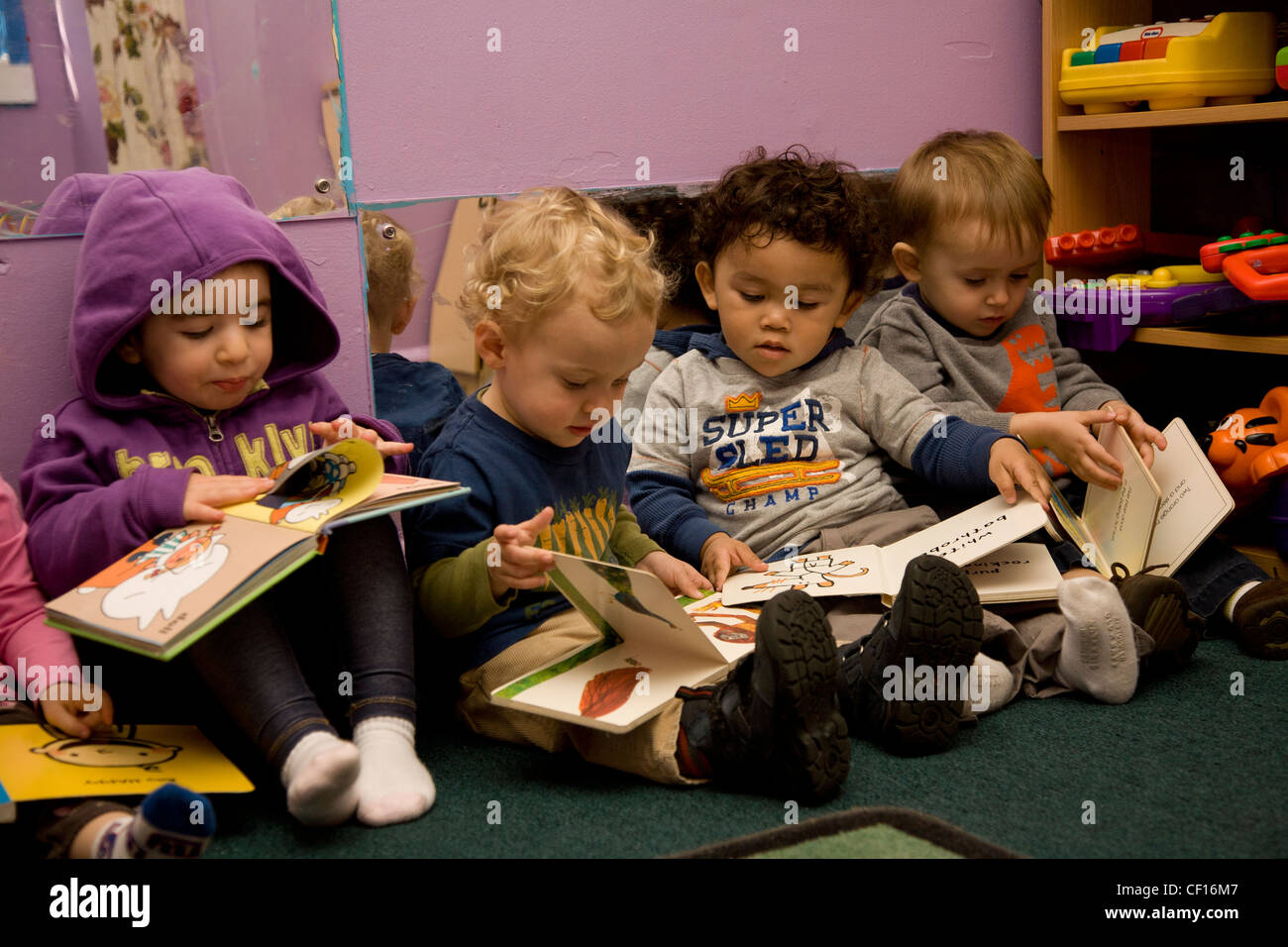 Nursery school children reading book hi-res stock photography and ...