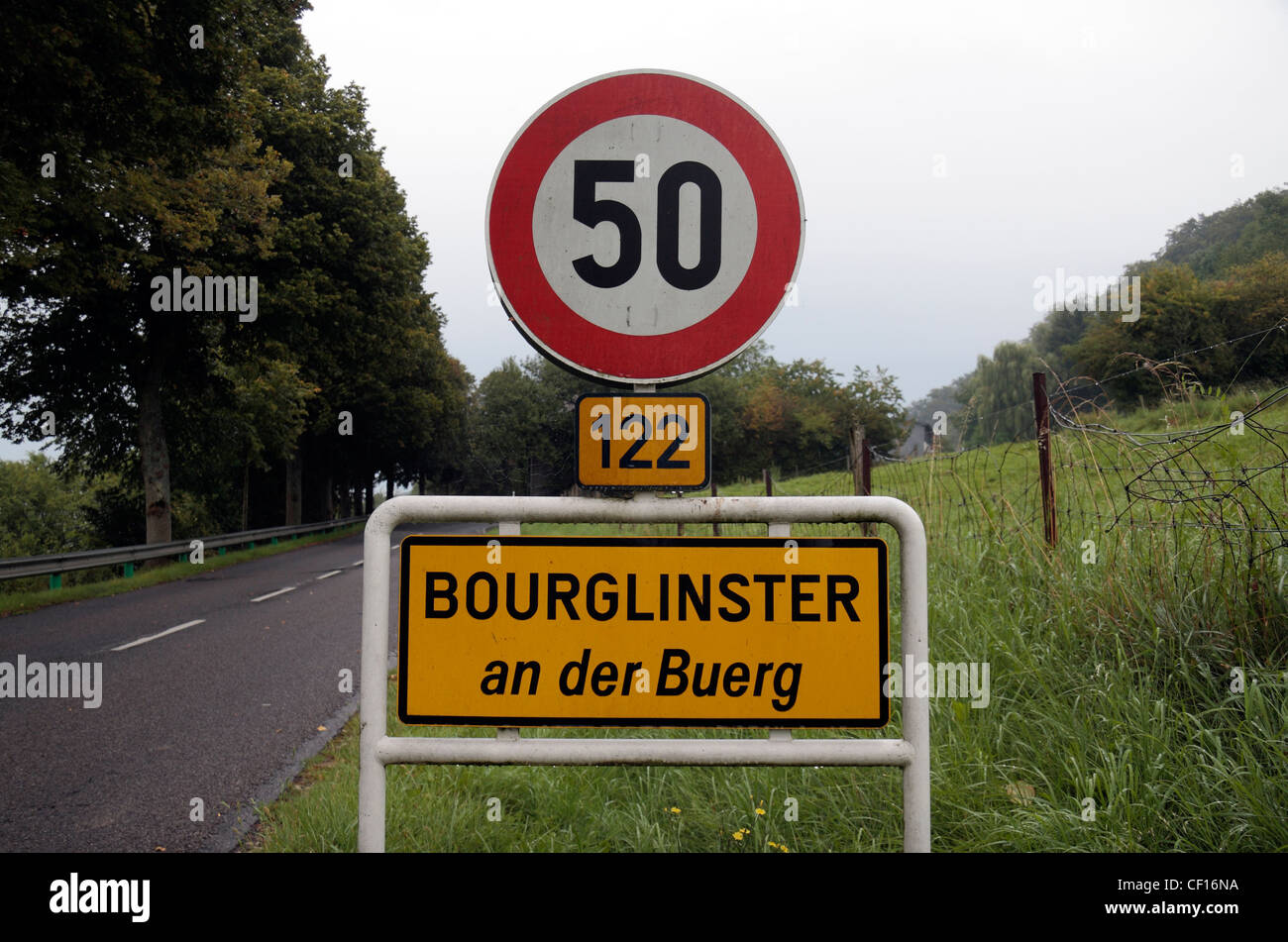 Typical town name sign with speed limit warning (50km/h) upon the ...