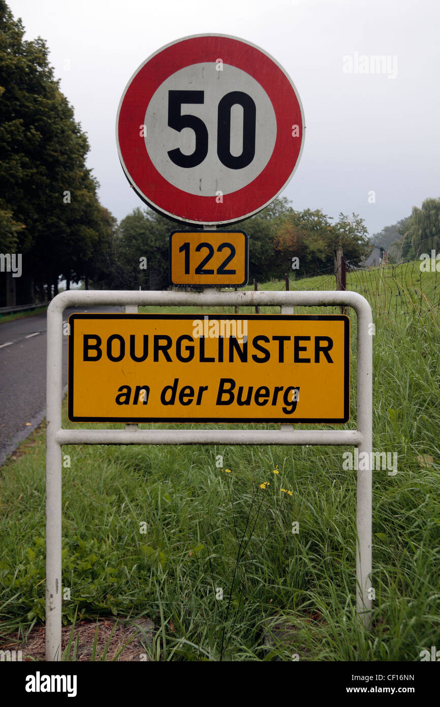 Typical town name sign with speed limit warning (50km/h) upon the ...