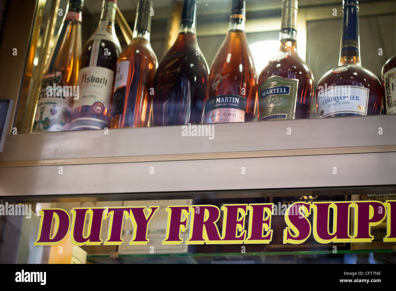 Detail of duty free shop window with displayed bottles of alcohol. Main ...