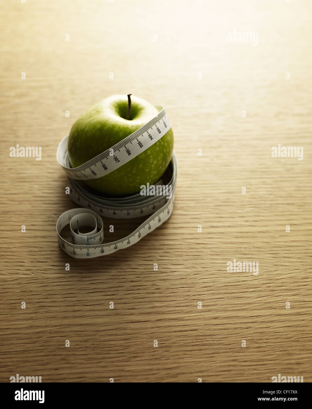 apple wrapped in a measuring tape Stock Photo - Alamy