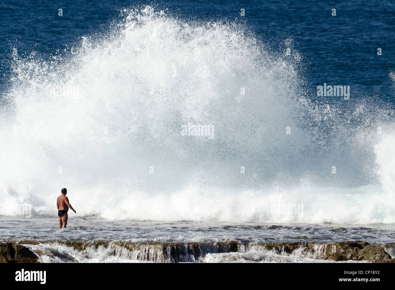 a big wave coming to a man Stock Photo - Alamy