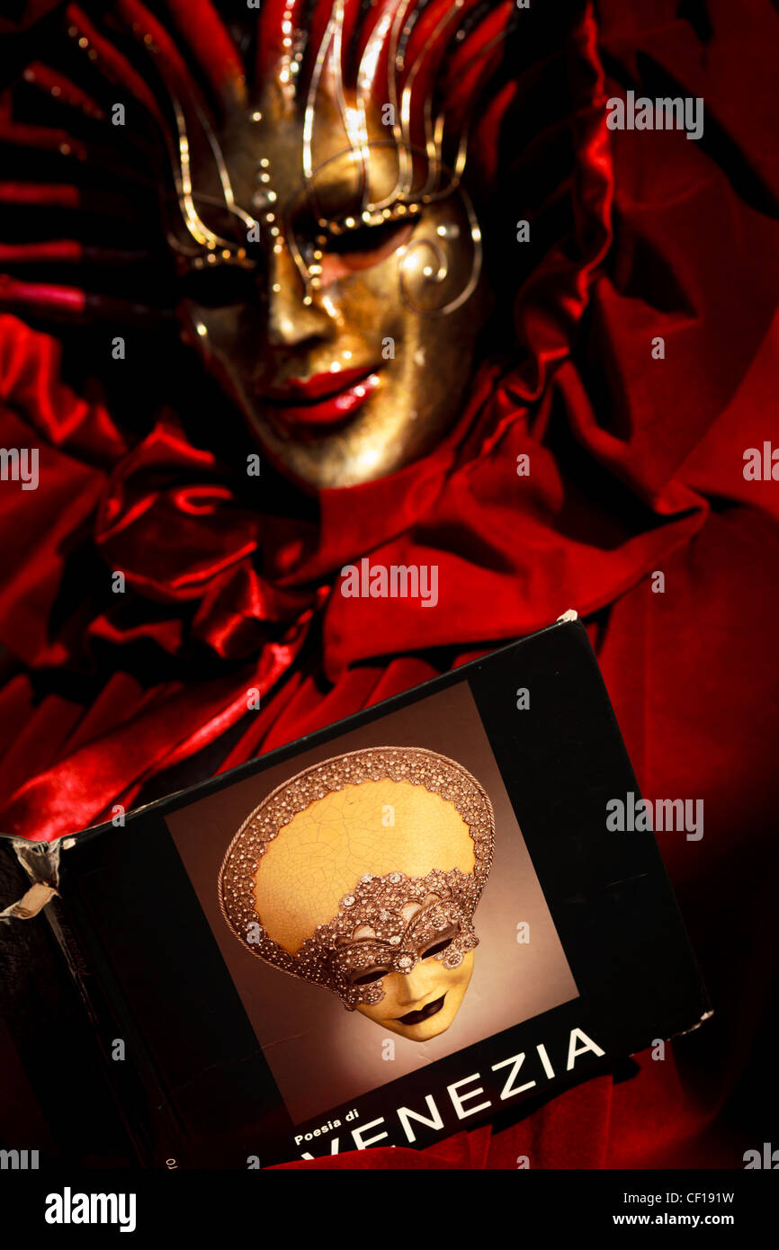 Woman with a golden mask reading poetry about Venice during the ...