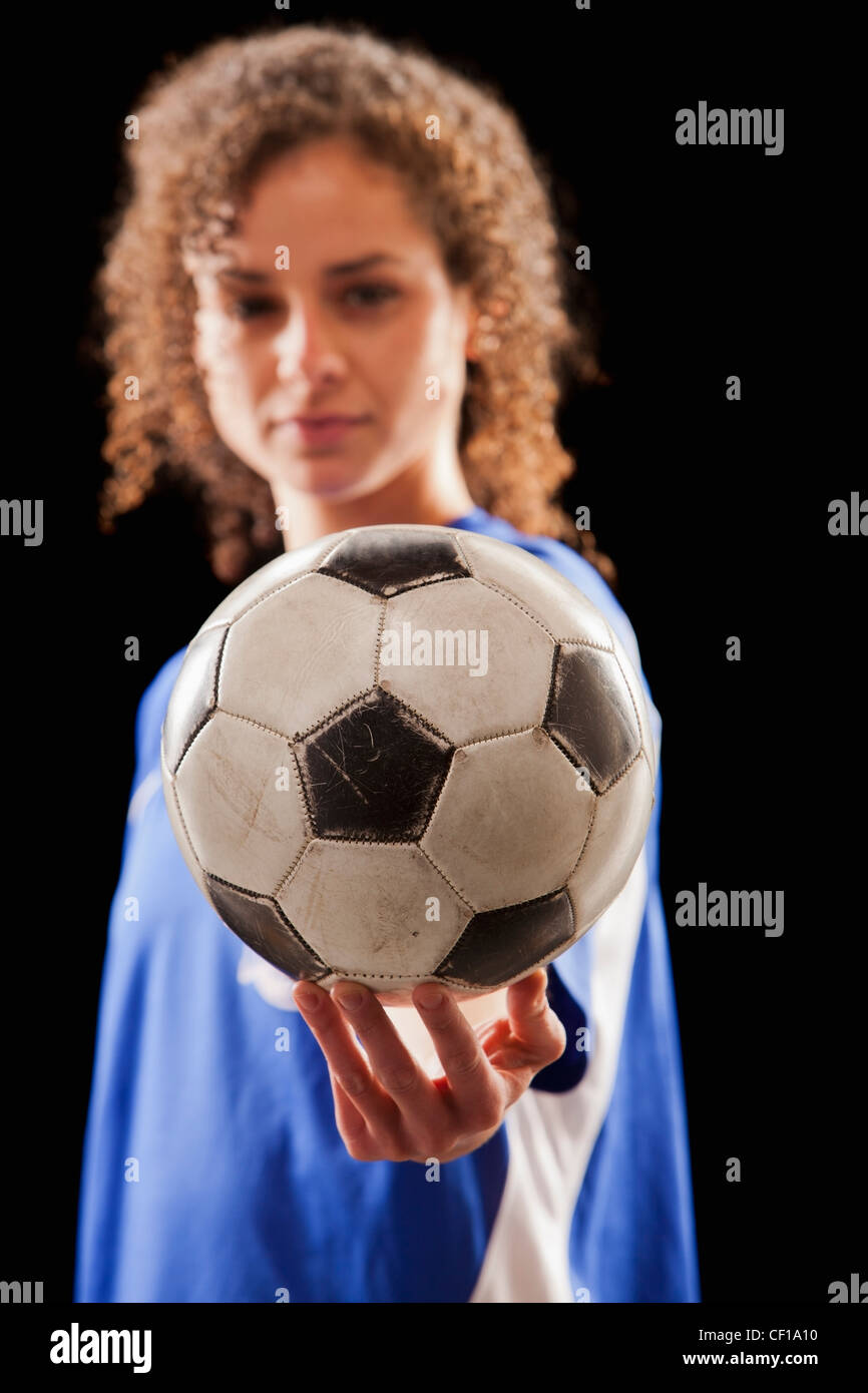 Caucasian soccer player holding ball Stock Photo - Alamy