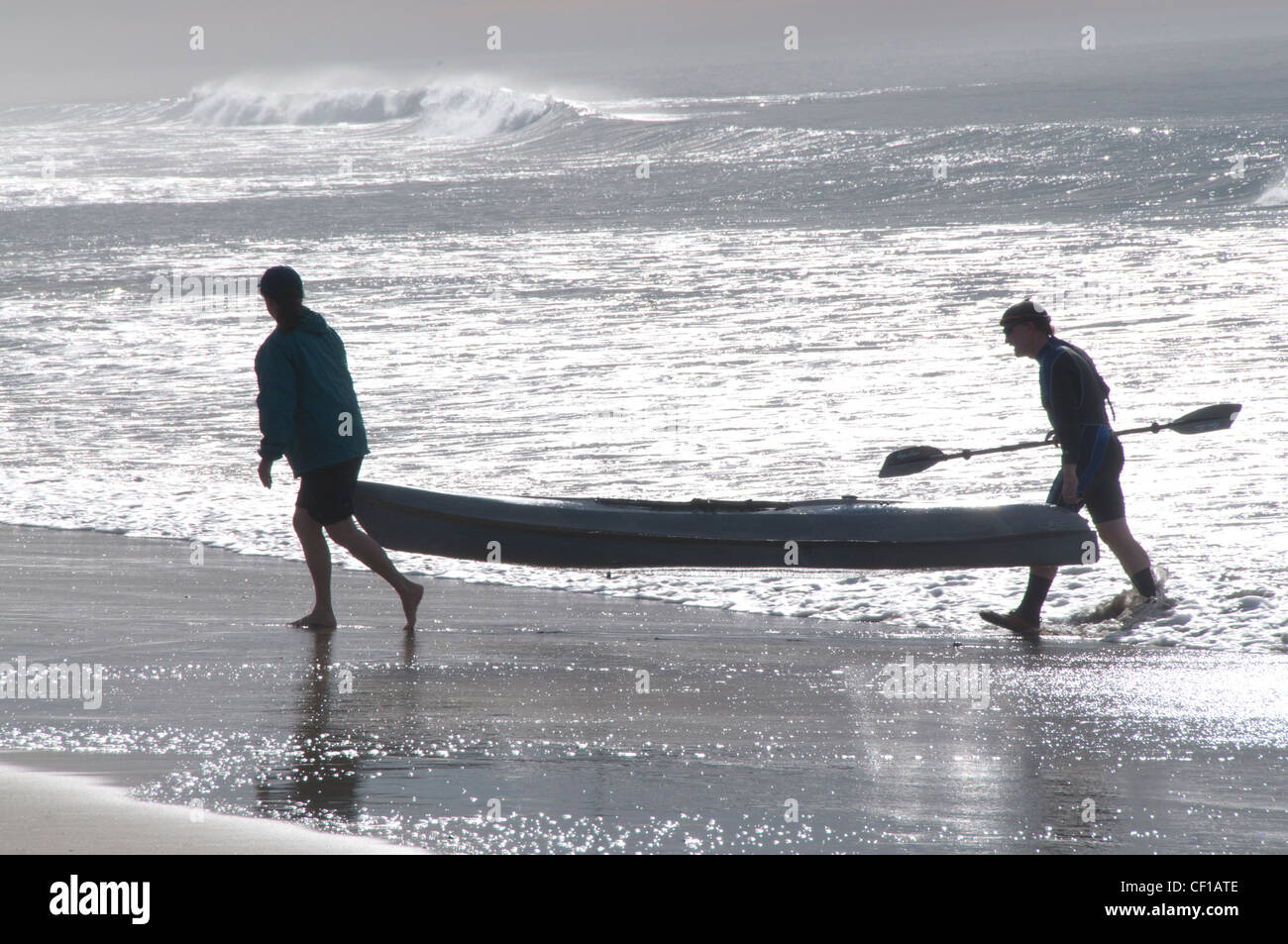 ocean kayak two men carrying Stock Photo - Alamy