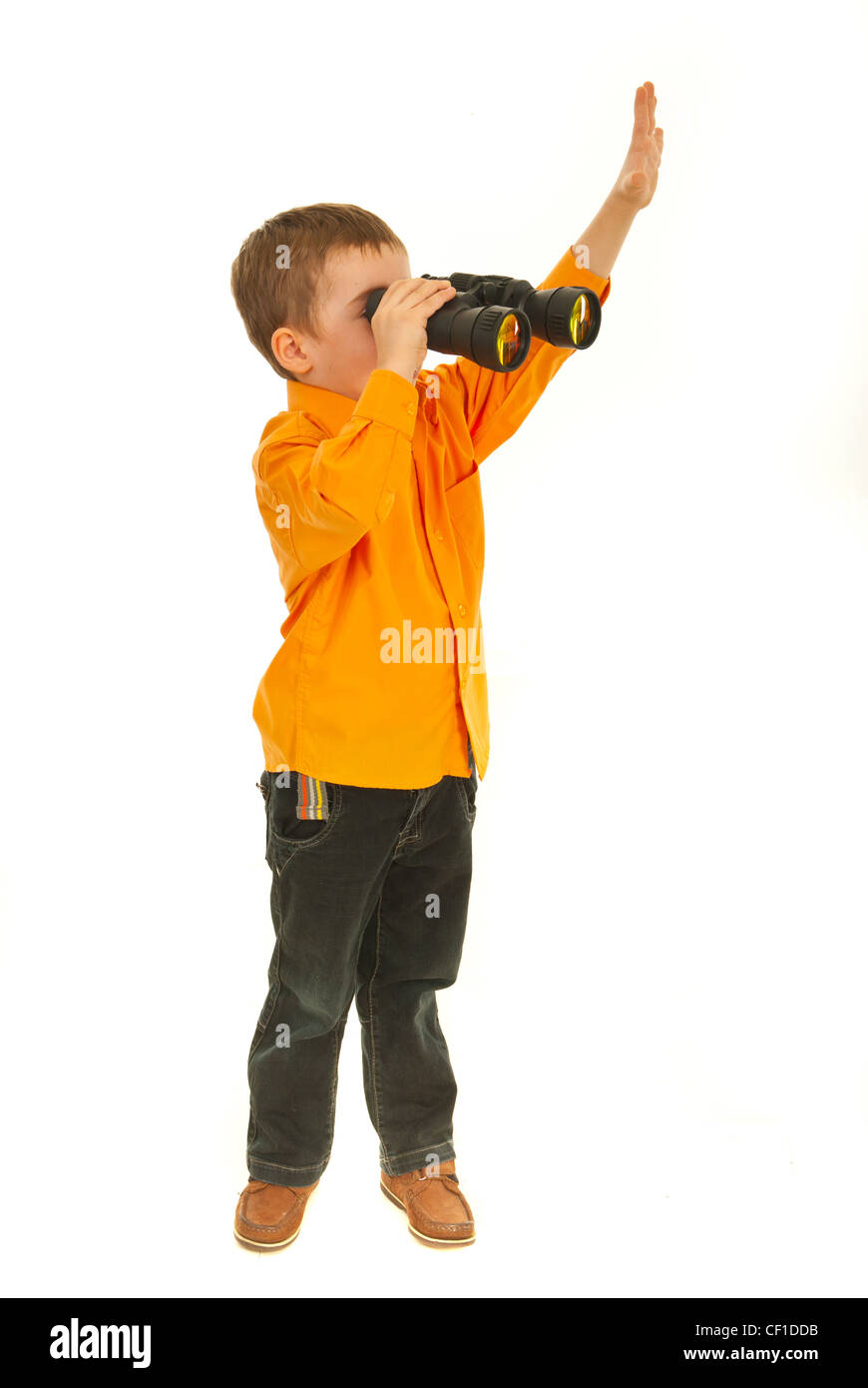 Boy looking thought binocular and raising palm to salute isolated on ...