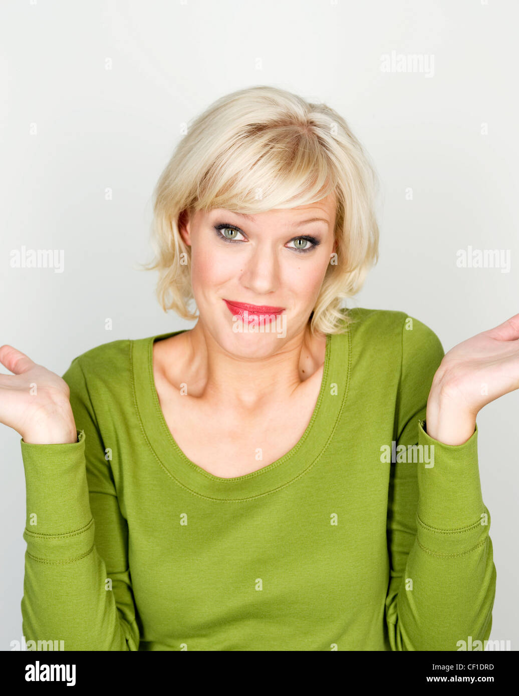 Female shrugging her shoulders with her palms up Stock Photo - Alamy