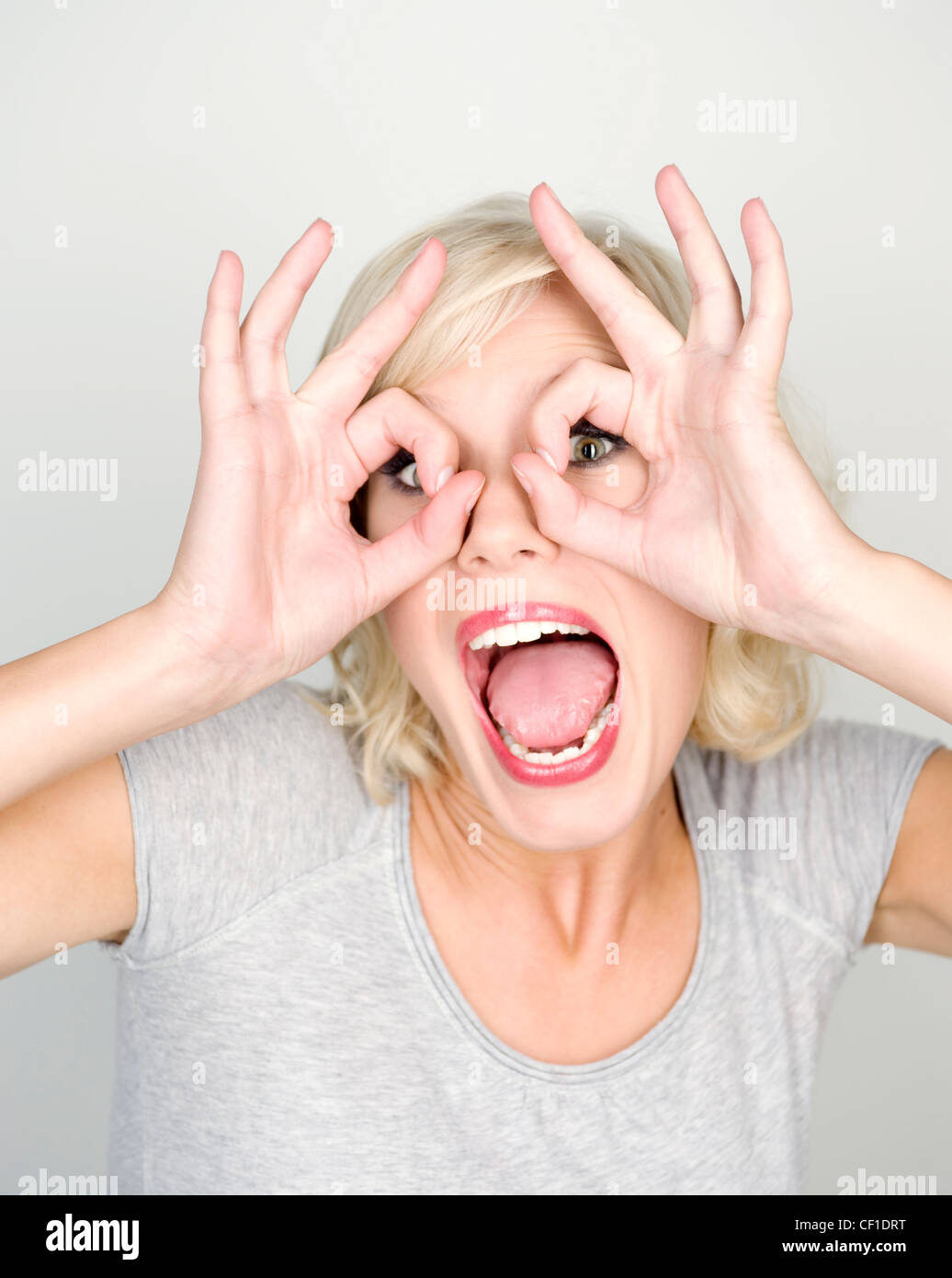 Female with hands making a funny face Stock Photo - Alamy