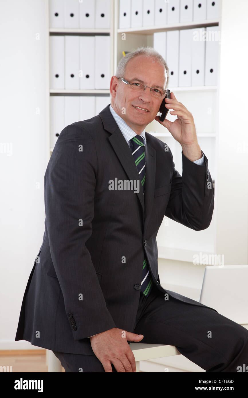 old business man with telephone in office Stock Photo - Alamy