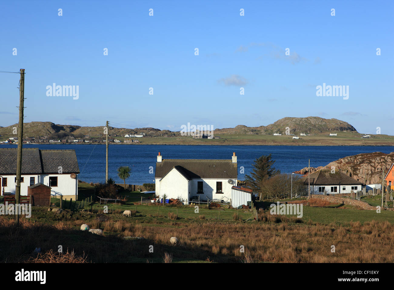 White cottages in Fionnphort on the Isle of Mull with the Isle of Iona ...