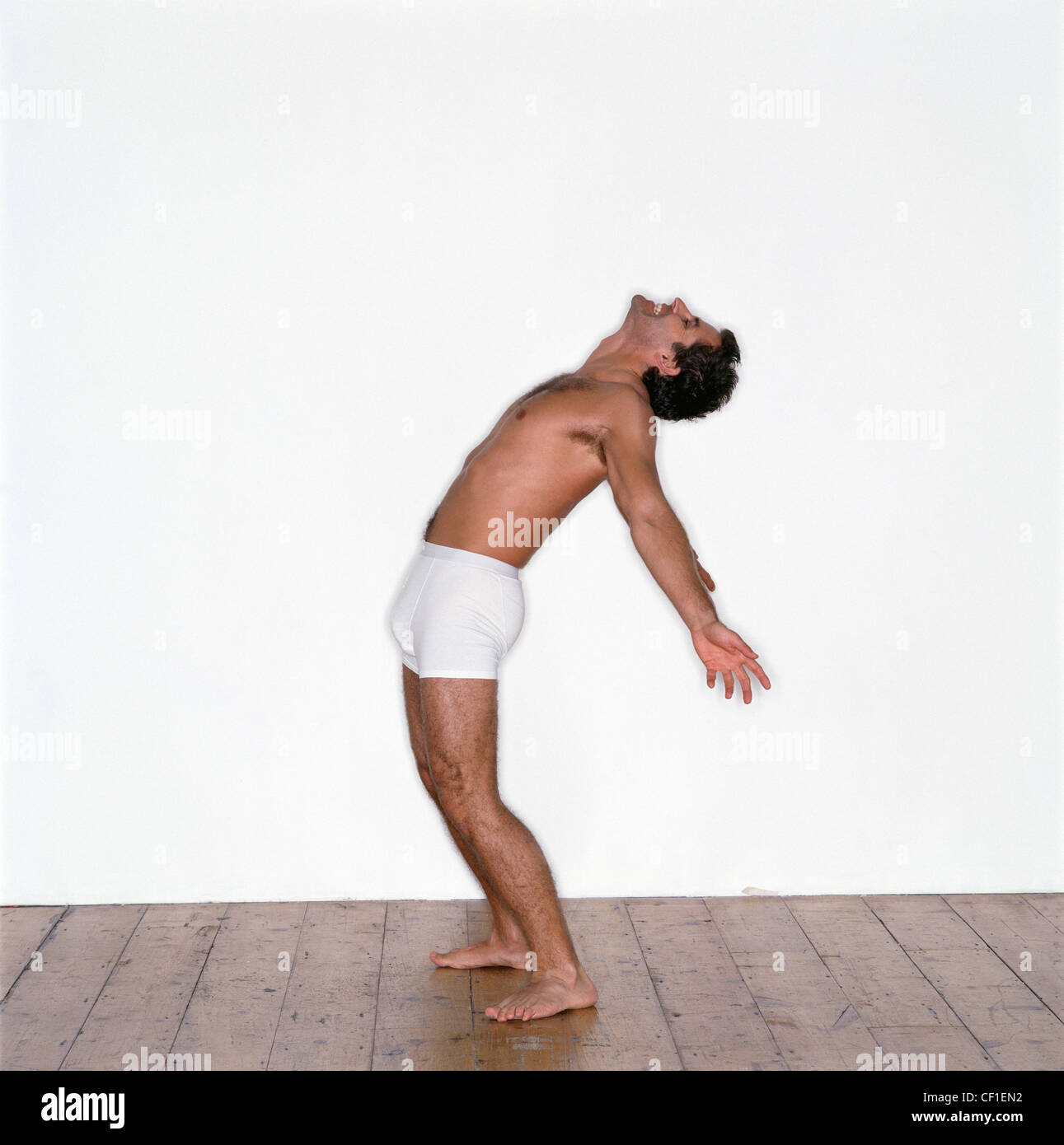 Male brunette hair, wearing white briefs, standing his face up, eyes ...