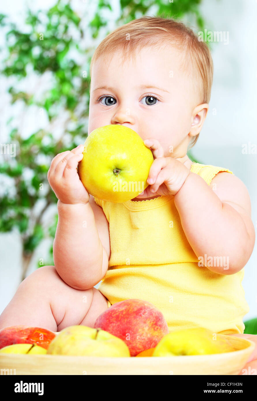 Little baby eating apple, closeup portrait, concept of health care ...