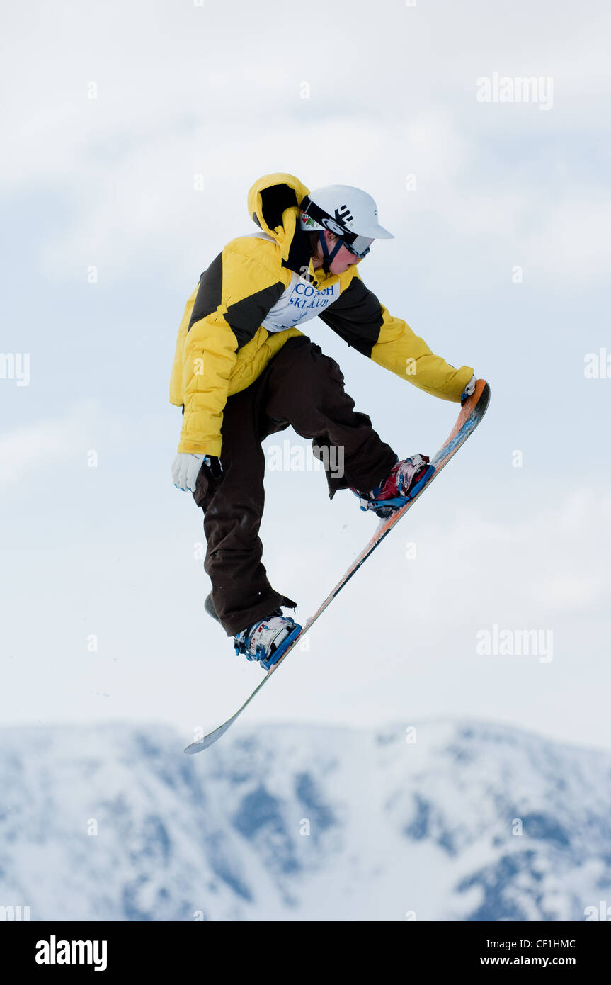 snowboarders getting big air during a competition at the summit of ...