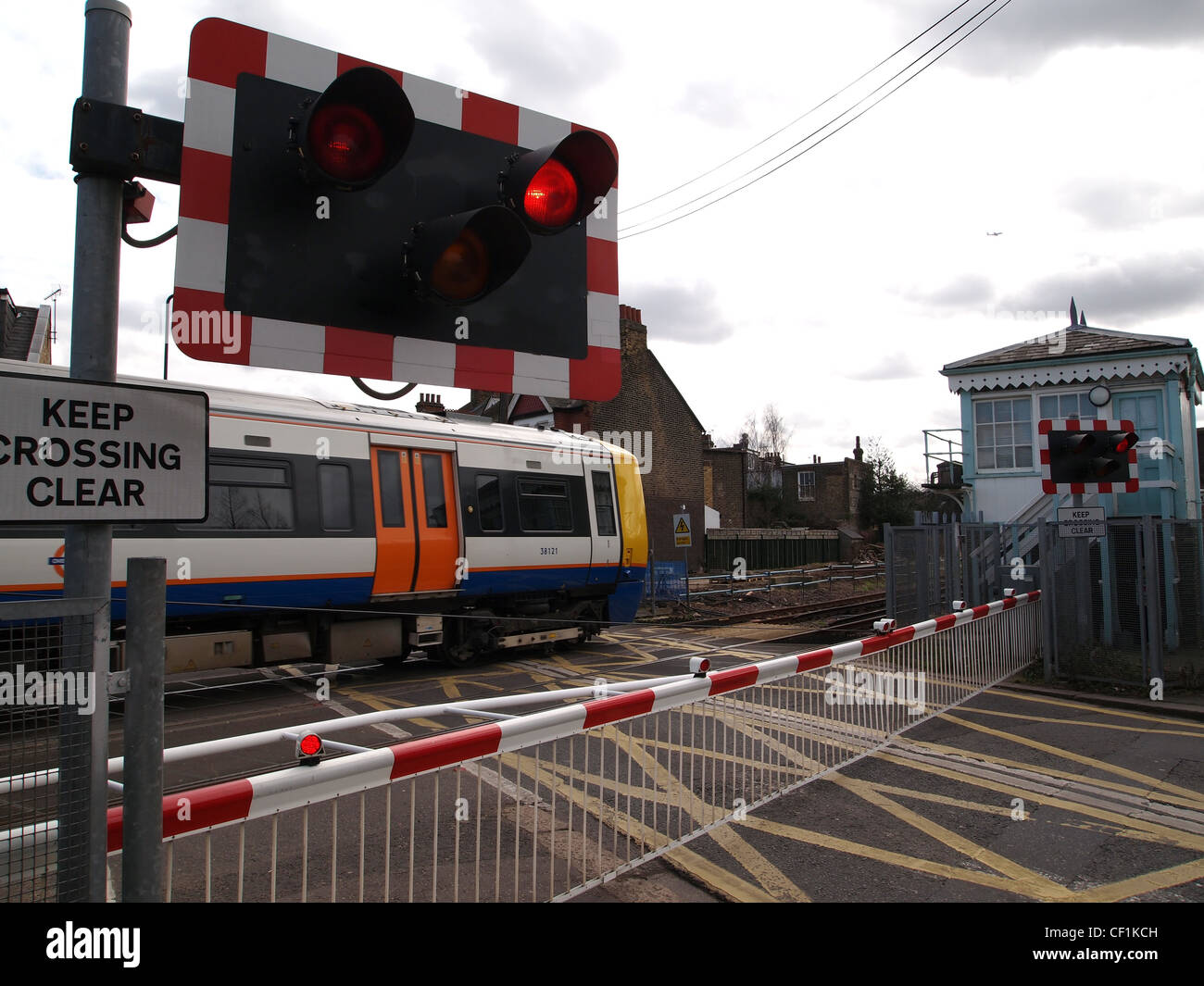 Train at railway crossing Stock Photo - Alamy