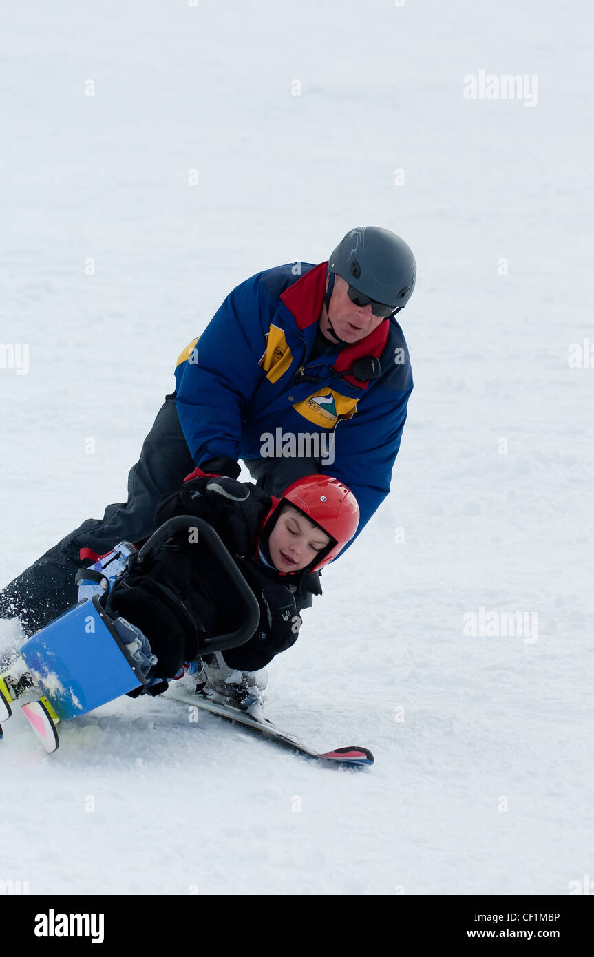 Disabled boy in special adapted sledge enjoys the ride Stock Photo - Alamy