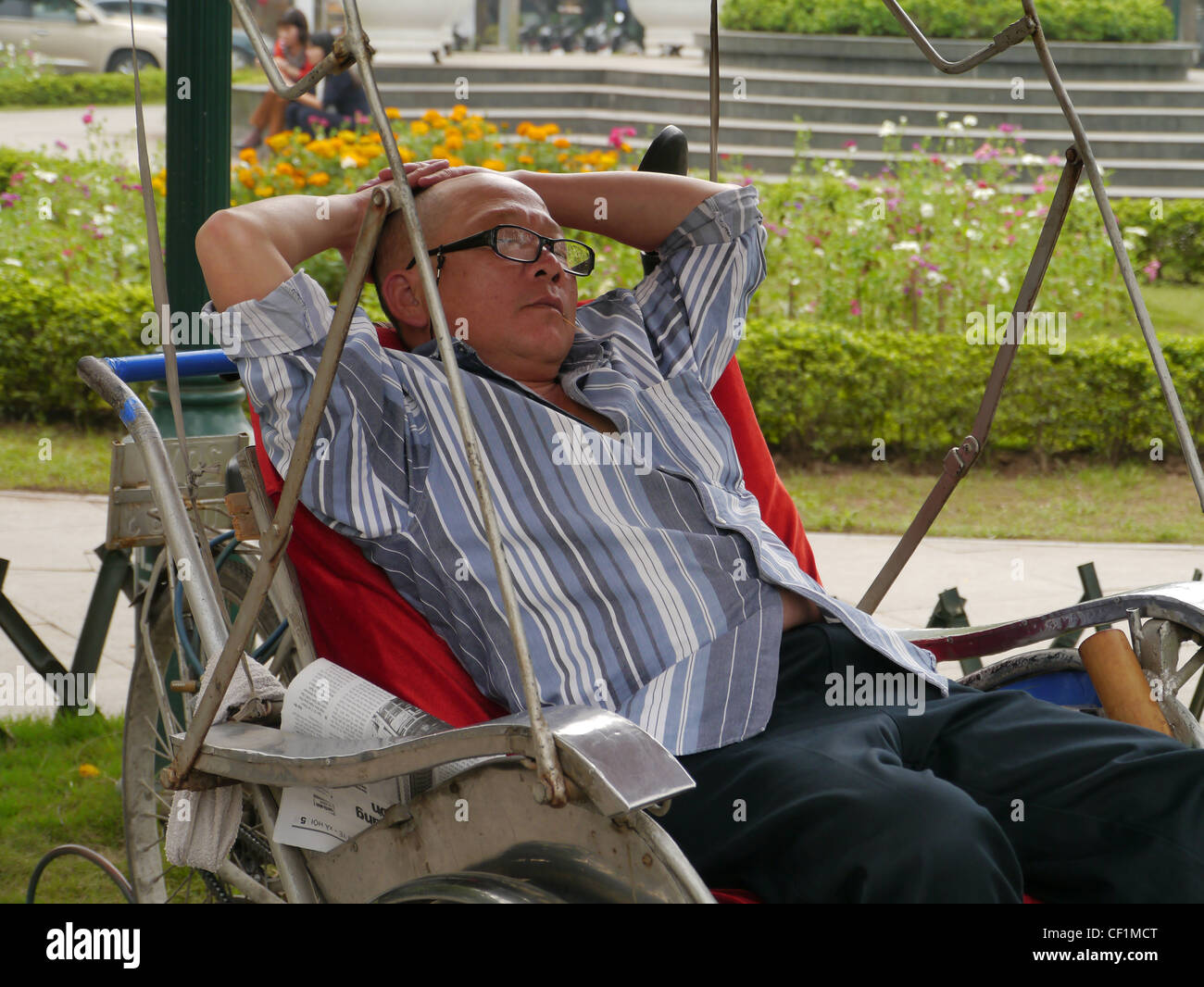 Old man having a siesta nap on his trishaw in Asia Stock Photo - Alamy
