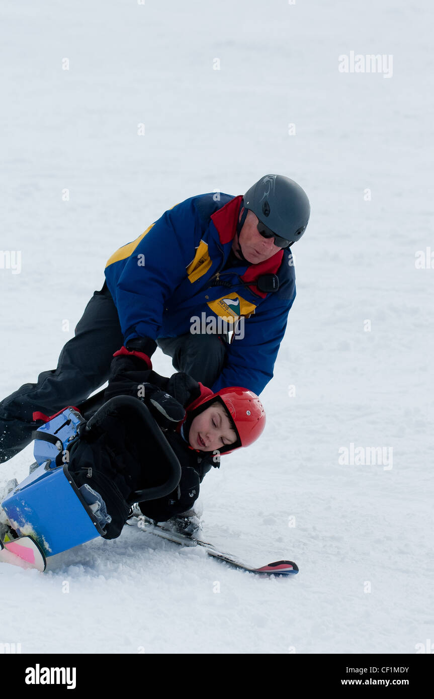 Disabled boy in special adapted sledge enjoys the ride Stock Photo - Alamy