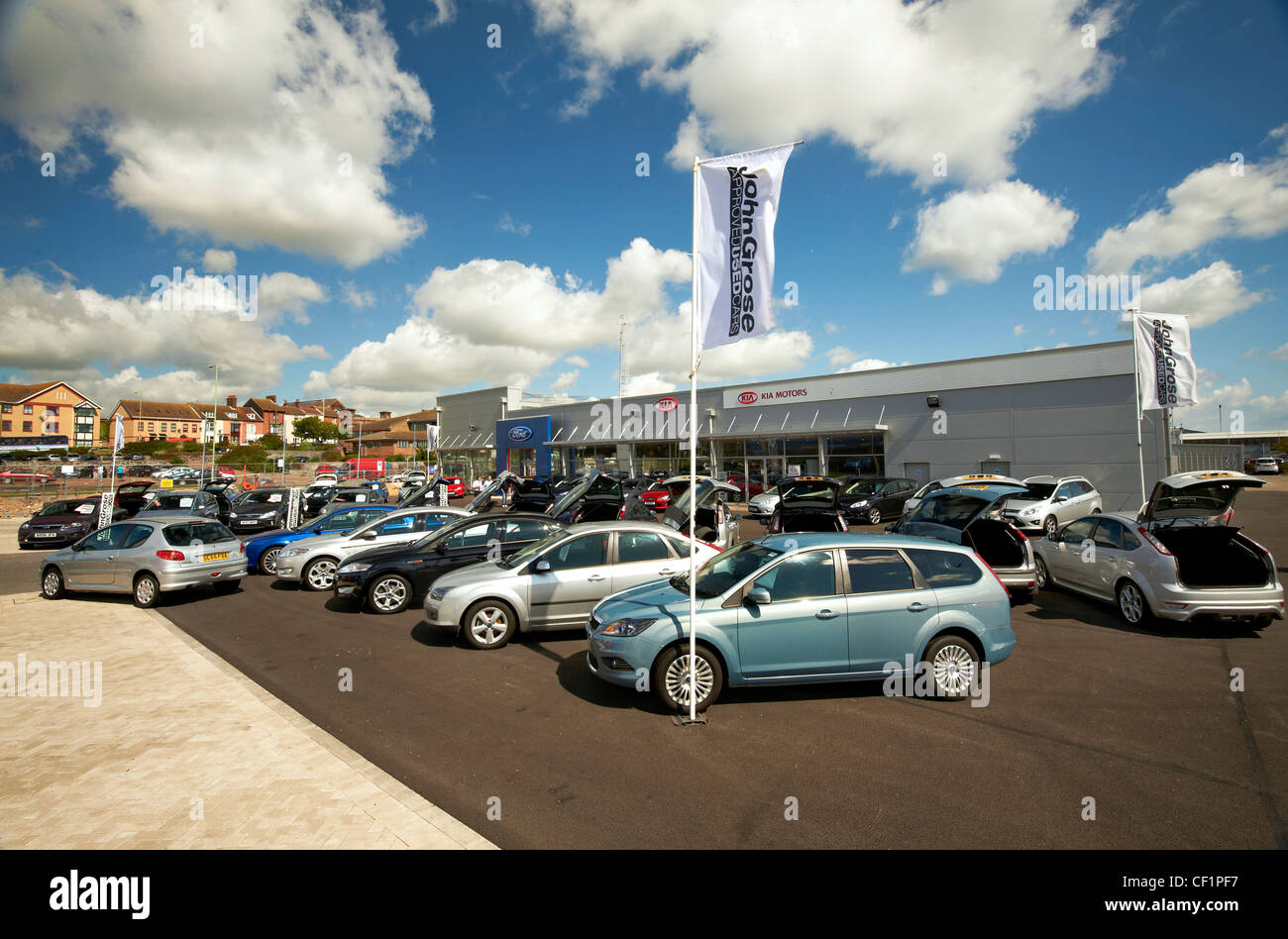 The forecourt of a car showroom in the UK, showing new cars for sale ...