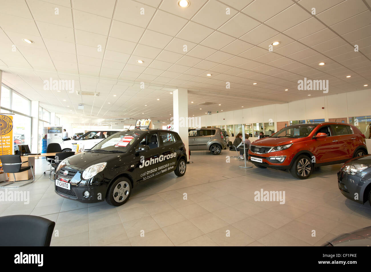 The interior of a car sales room showing a number of new vehicles for ...