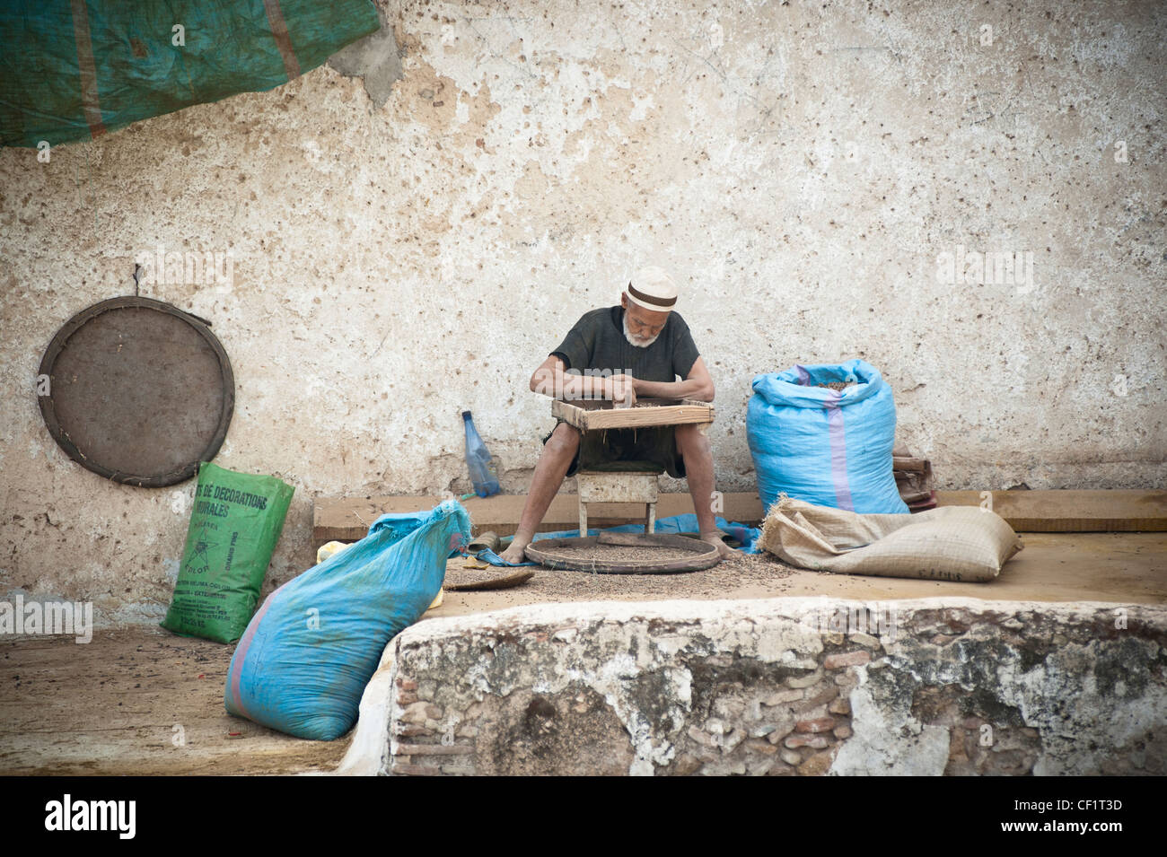 Old man selecting pigeon poo to soften the leatherat the Chouwara ...