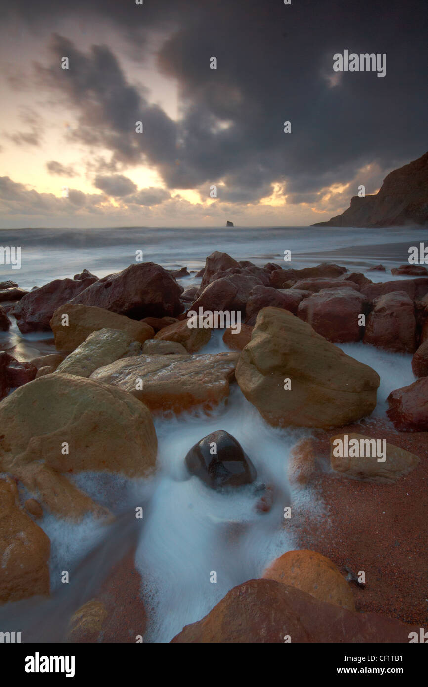 Pools of water forming inbetween rocks on the beach at Saltwick Bay ...
