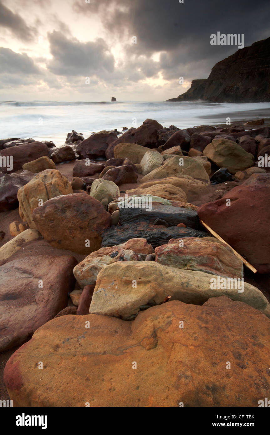 A view over the rocky coastline at Saltwick Bay towards waves rolling ...