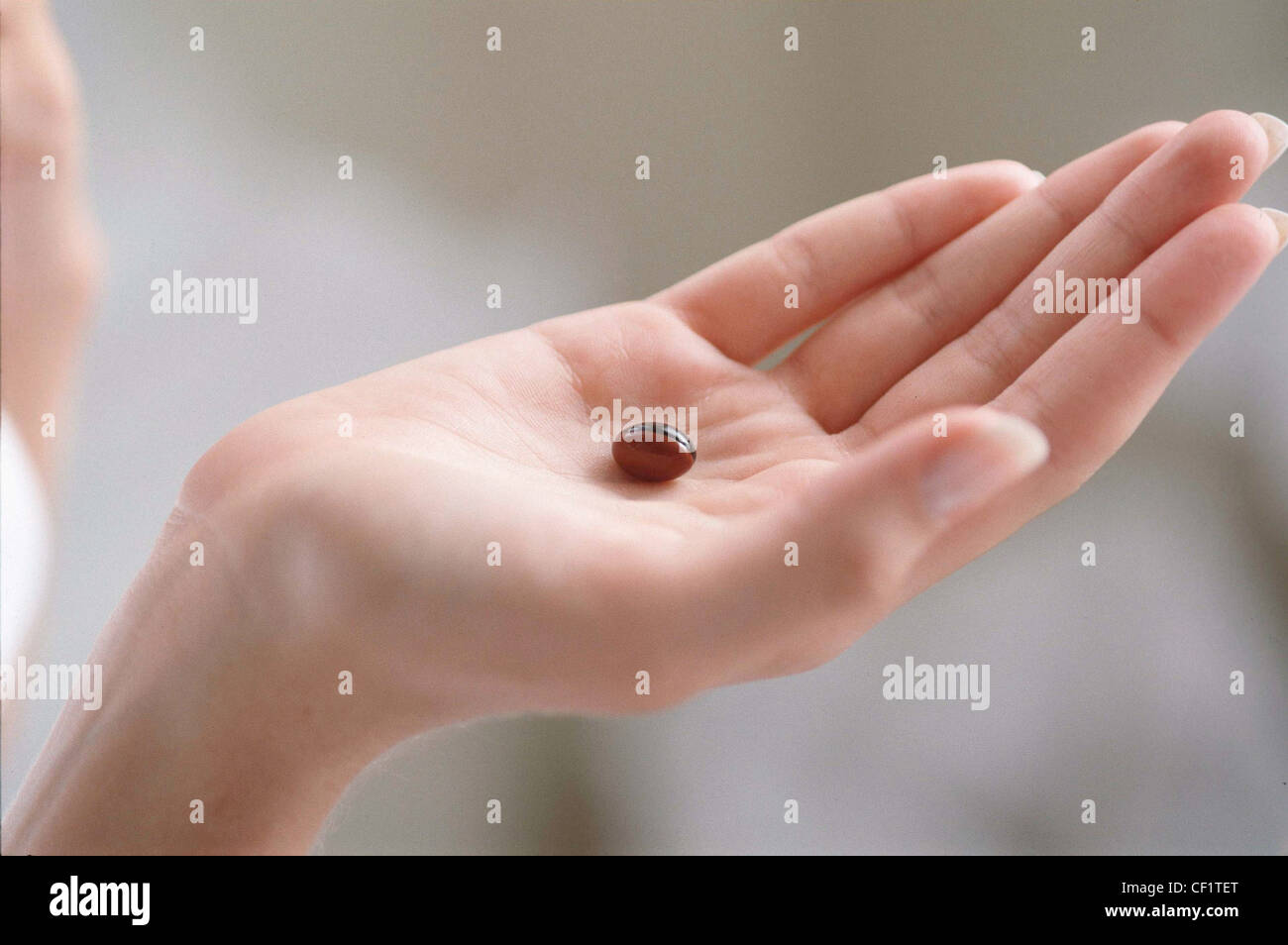 Detail of Female hand holding gel capsule Stock Photo - Alamy