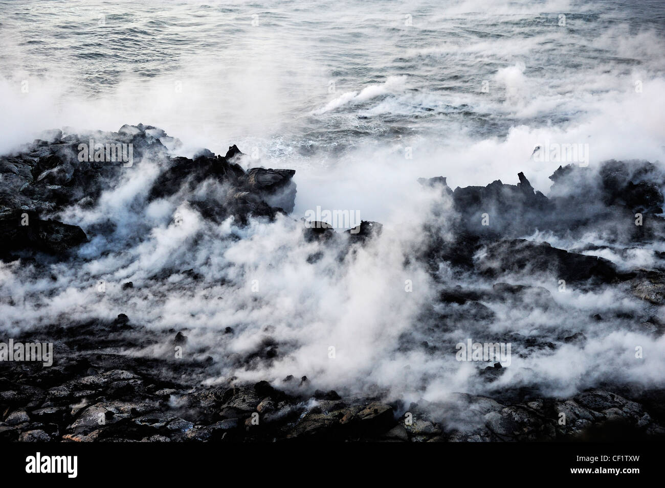 Steam rising off lava flowing into ocean, Kilauea Volcano, Big Island ...