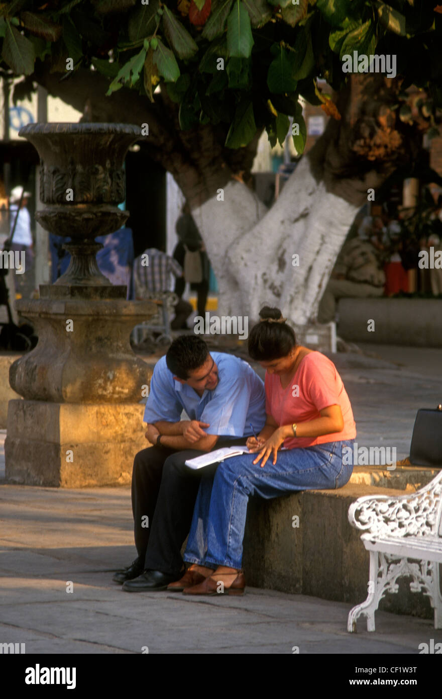 Mexicans Mexican people person man and woman couple sitting in plaza ...