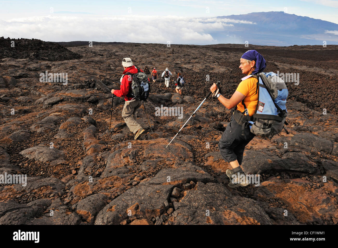 Hikers hiking in the Hawaii Volcanoes National Park walking on cooled ...