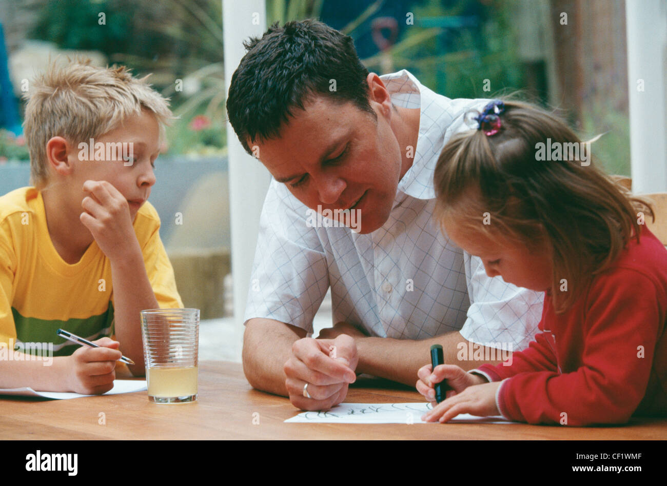 Father short brown hair sitting at table male child blonde spiky hair ...