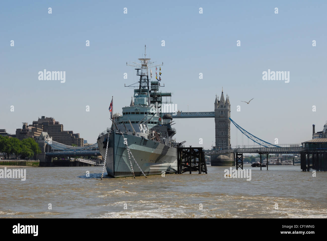 HMS Belfast and Tower Bridge on the River Thames. HMS Belfast is the ...