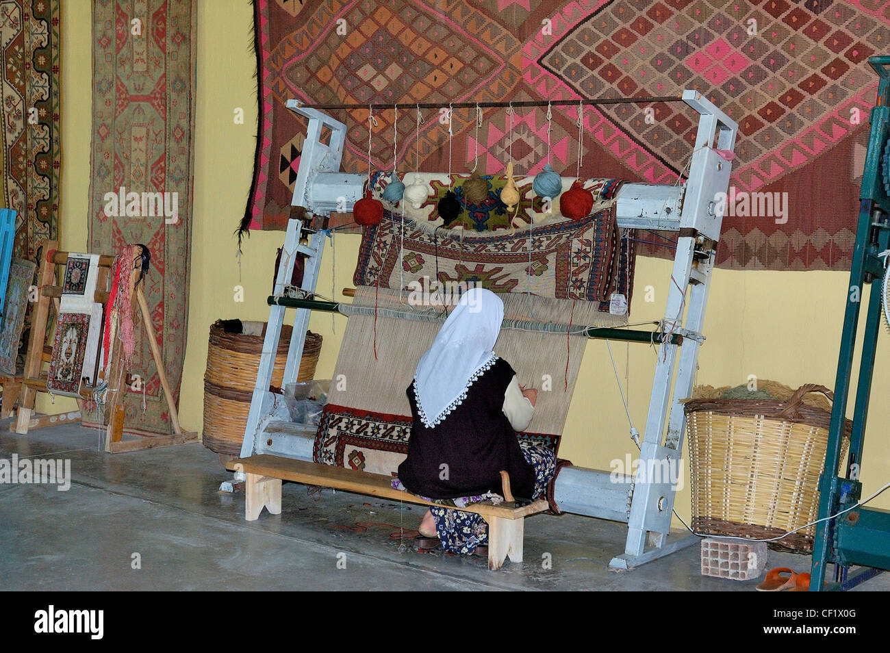 turkish woman working on a weaving loom in a carpet factory dalaman ...