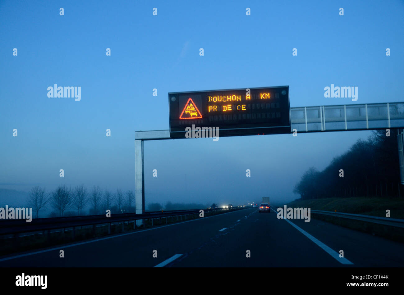 Warning sign on highway, at dusk, France Stock Photo - Alamy