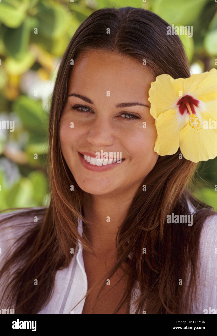 Hibiscus flower behind ear hi-res stock photography and images - Alamy