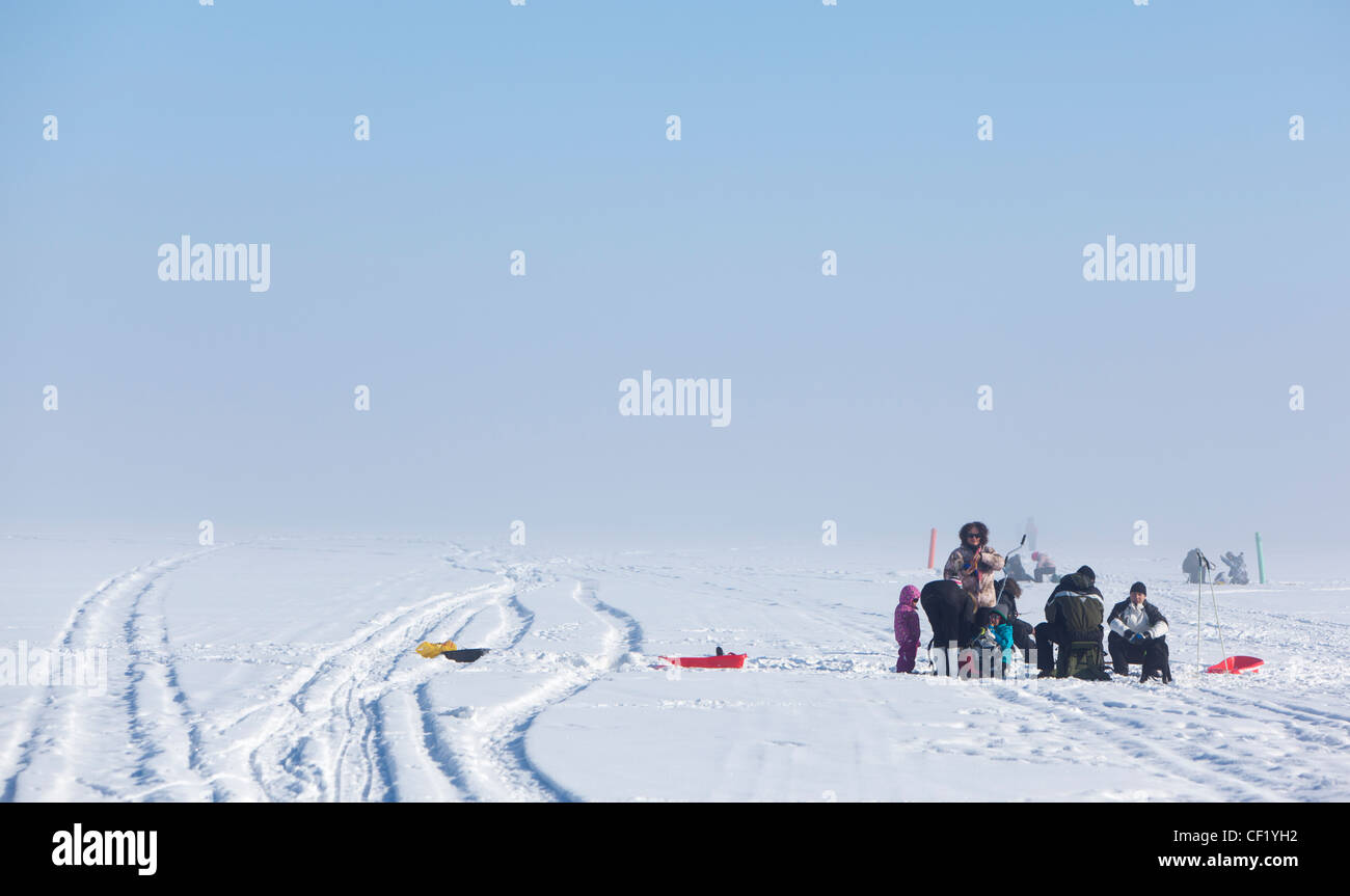 Family ice fishing at sea ice at Bothnian Bay , Baltic Sea , Finland ...